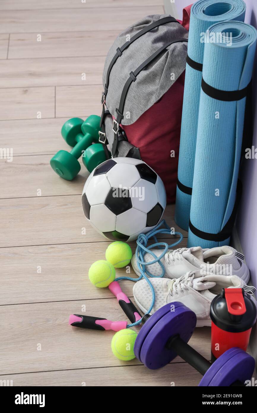 Set of different sports equipment on floor Stock Photo - Alamy