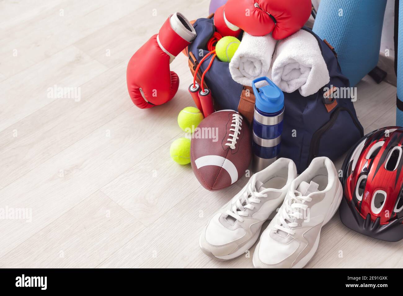 Set of different sports equipment on floor Stock Photo - Alamy