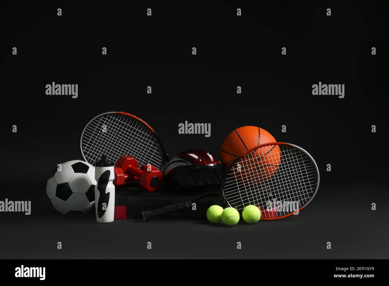 Set of sports equipment on dark background Stock Photo - Alamy
