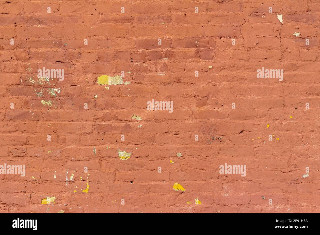 Old deteriorating rusty red color painted brick wall texture background ...
