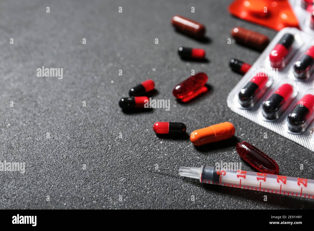 Syringe with drugs on dark background Stock Photo - Alamy