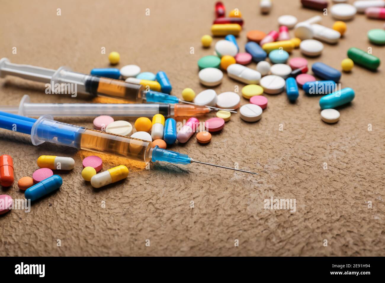 Syringes with drugs on color background Stock Photo - Alamy