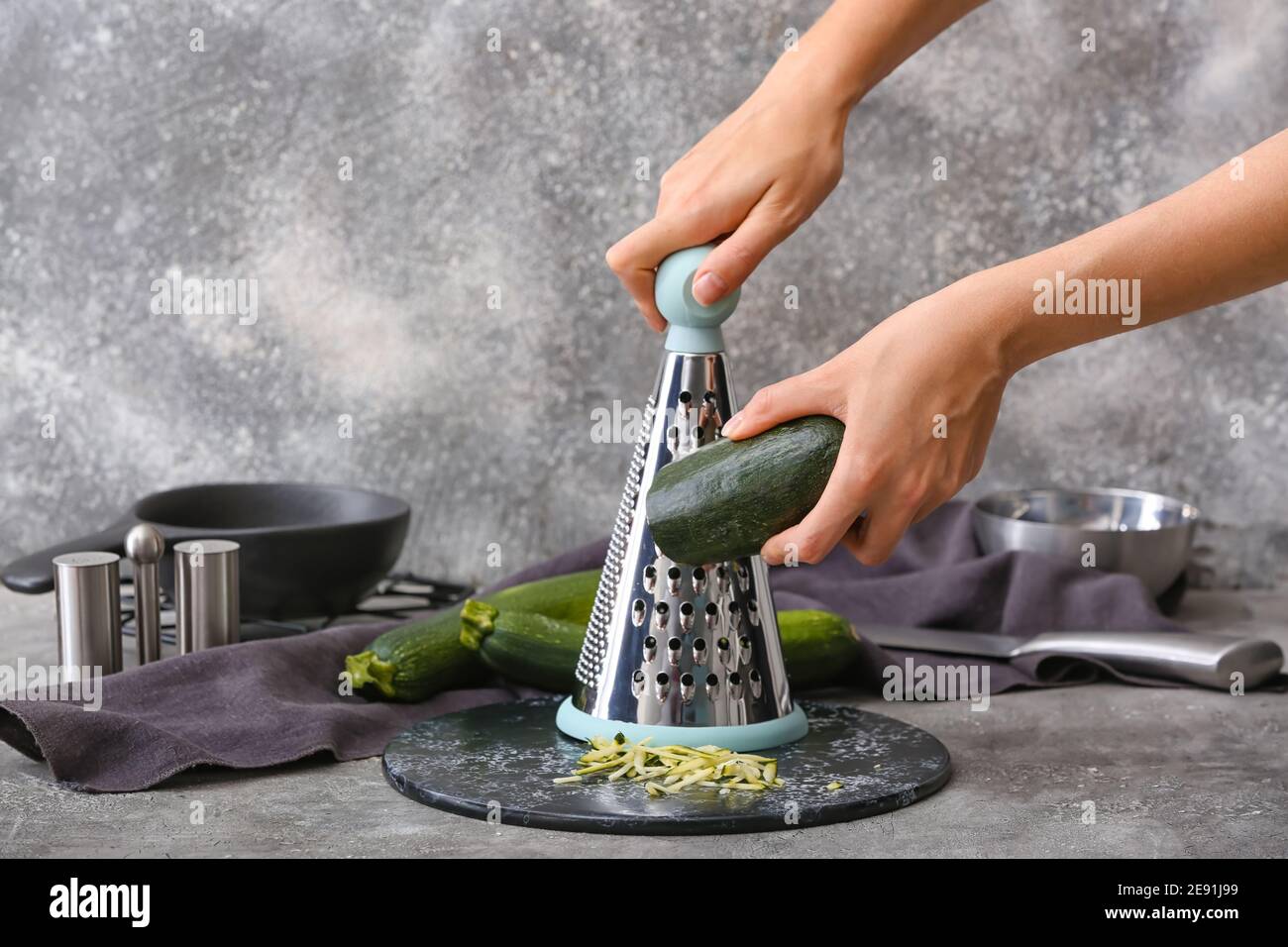 Woman grating zucchini table hi-res stock photography and images - Alamy