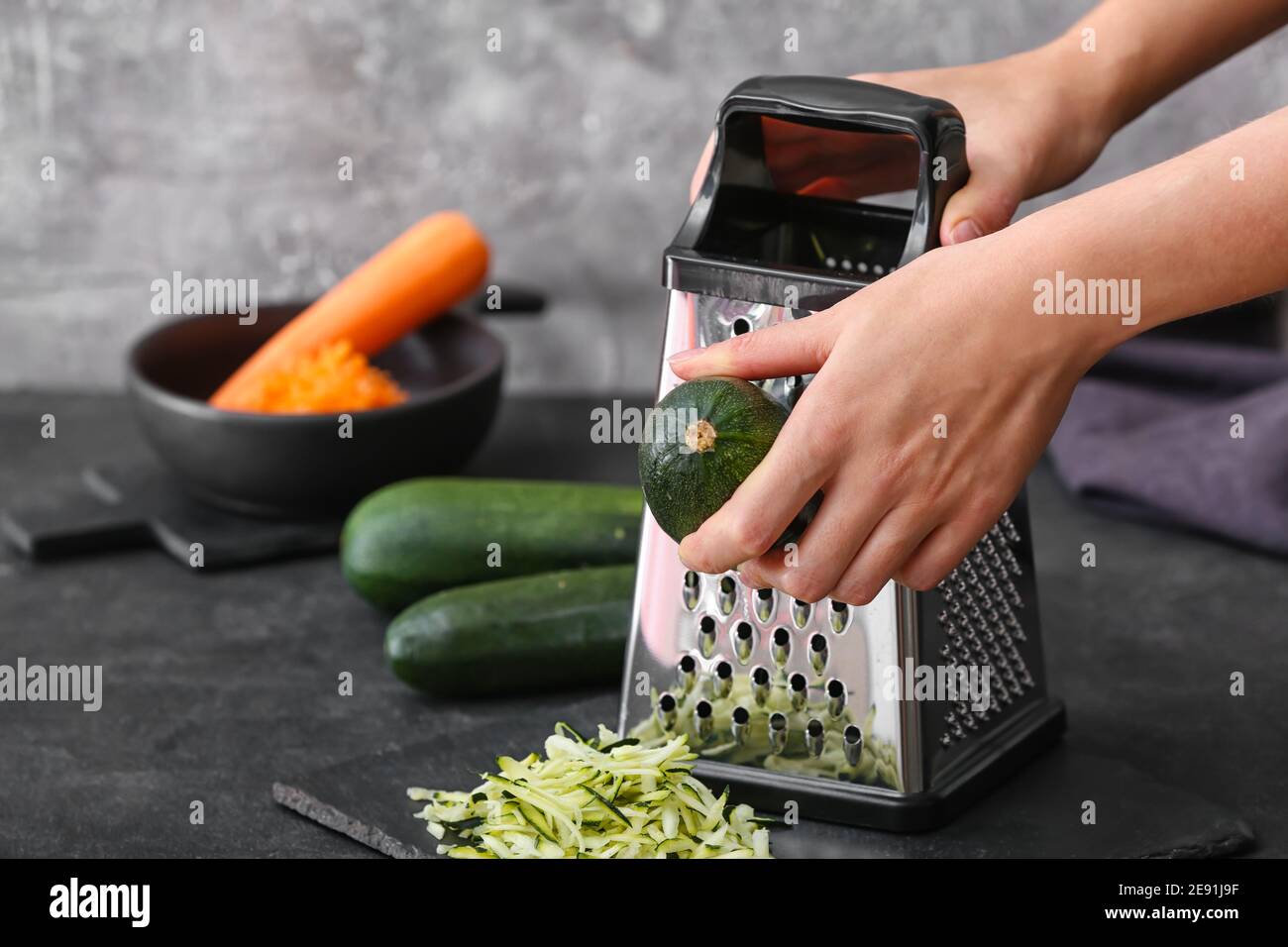 Woman grating zucchini table hi-res stock photography and images - Alamy