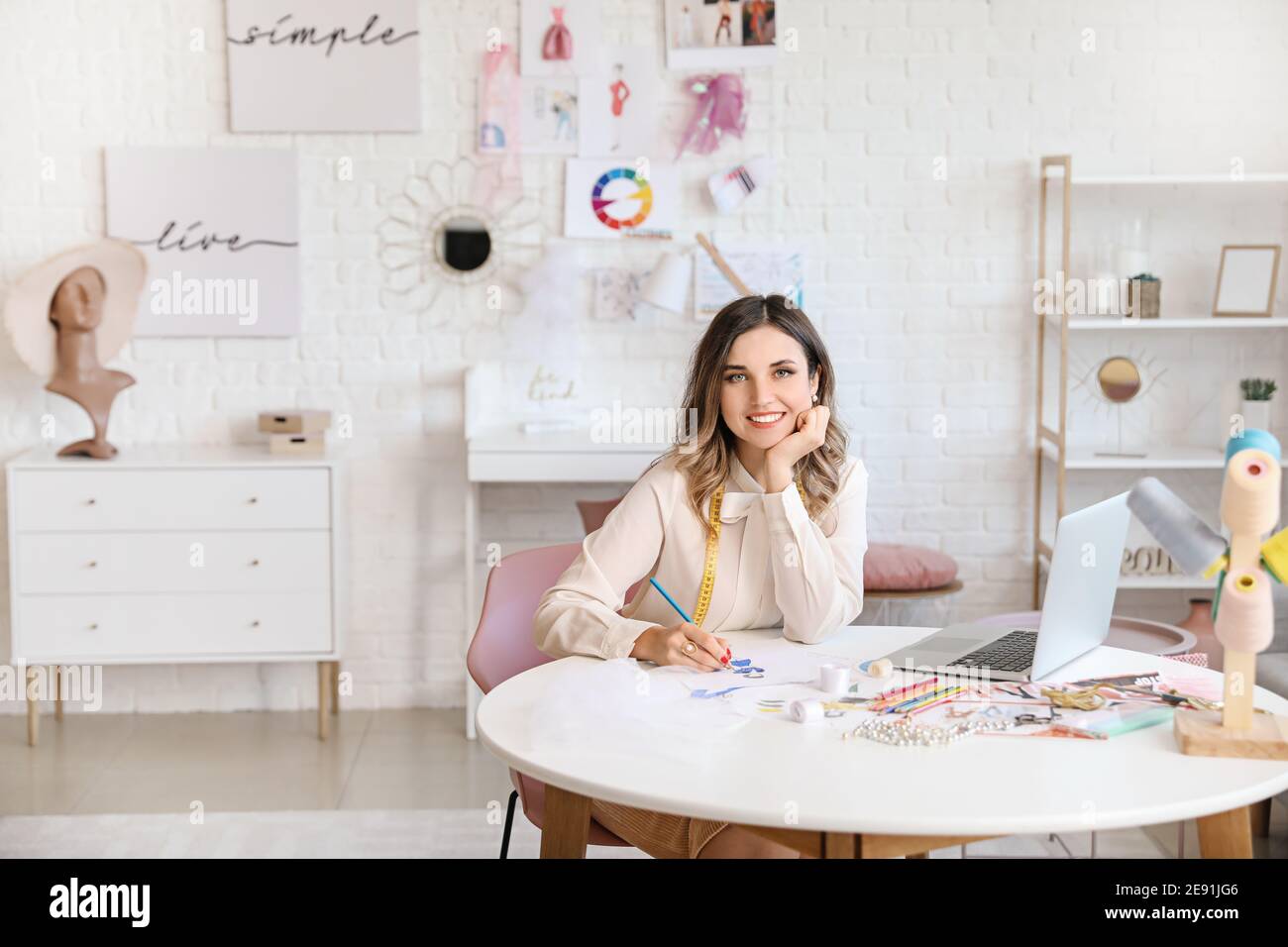 Female fashion designer working in studio Stock Photo - Alamy