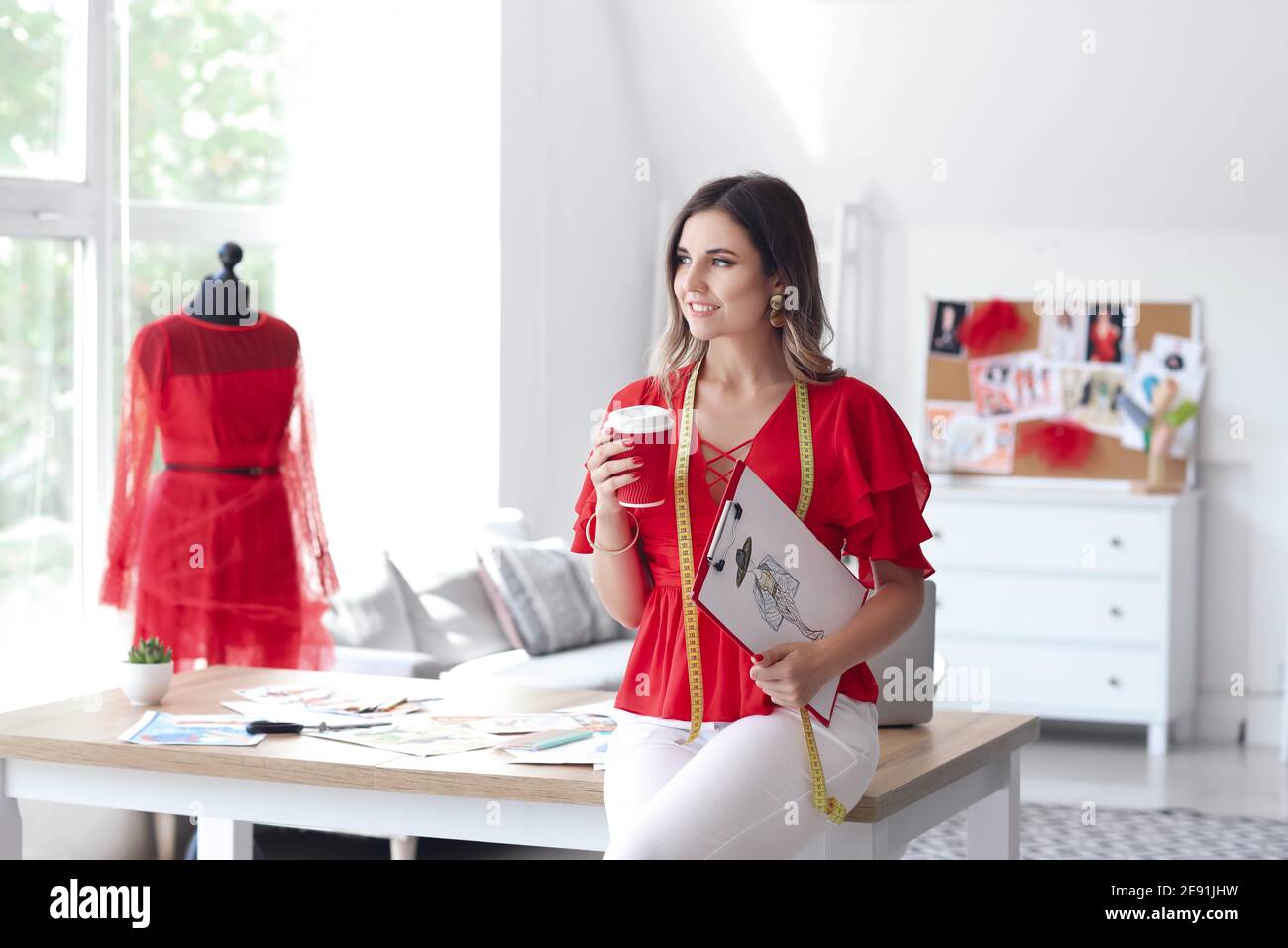 Female fashion designer working in studio Stock Photo - Alamy