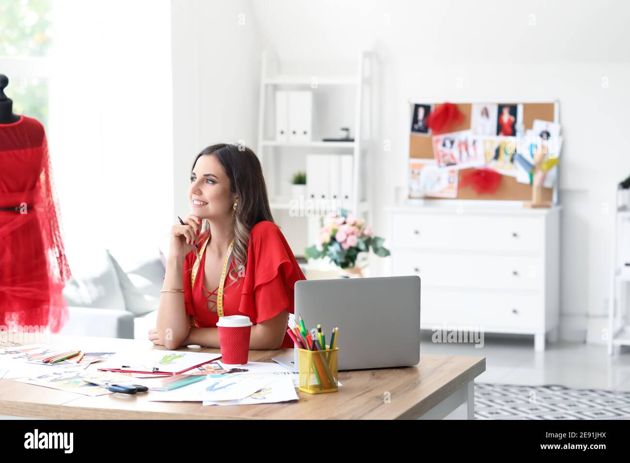 Female fashion designer working in studio Stock Photo - Alamy