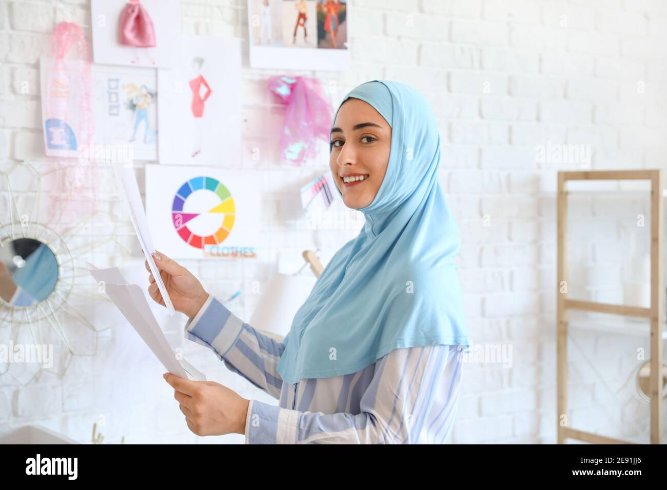 Female Muslim fashion designer working in studio Stock Photo - Alamy
