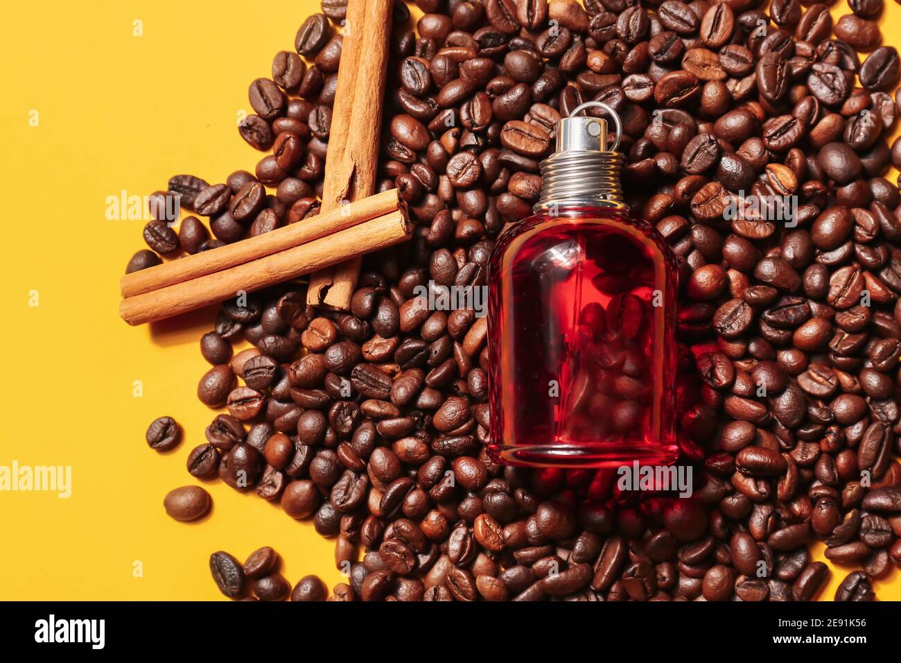 Bottle of perfume with coffee beans on color background Stock Photo - Alamy