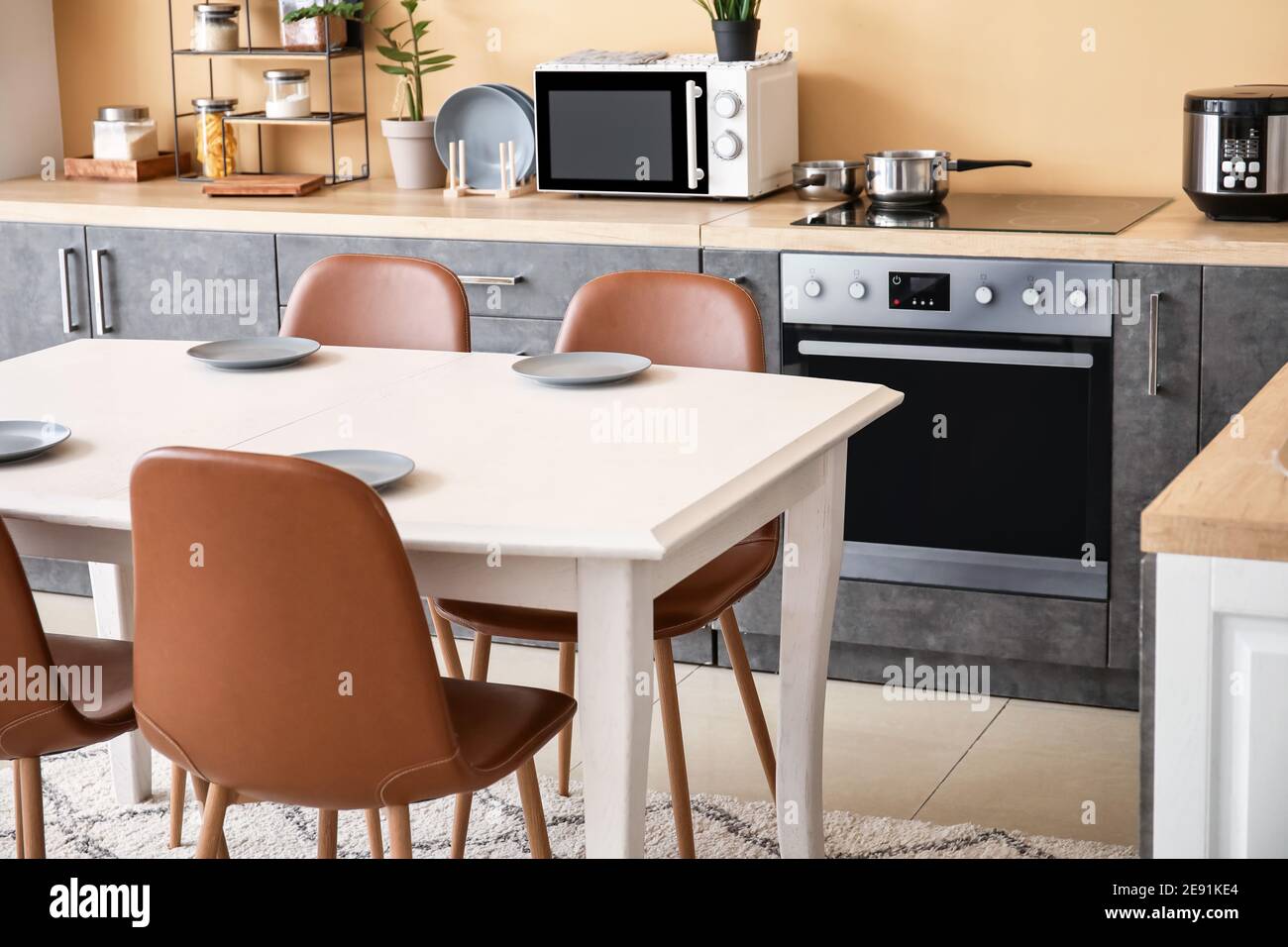 Dinning table in interior of modern kitchen Stock Photo - Alamy