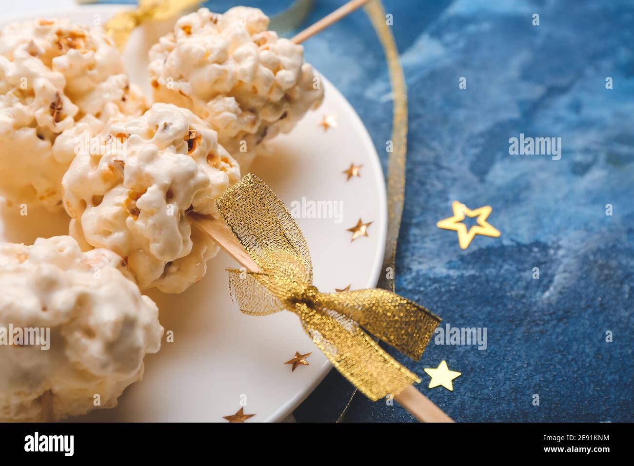 Plate with tasty popcorn balls on color background Stock Photo - Alamy