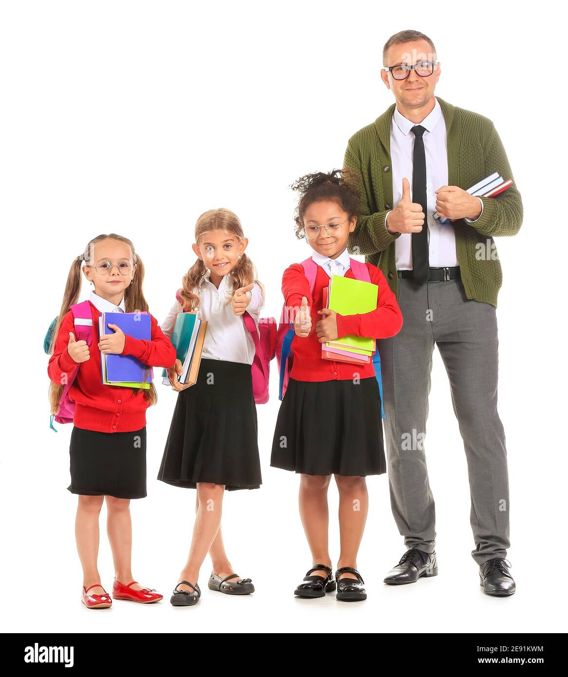 Little schoolgirls with teacher on white background Stock Photo - Alamy