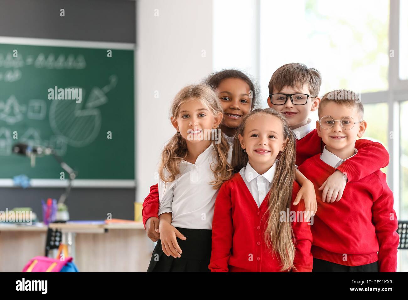 Cute little pupils in classroom Stock Photo - Alamy