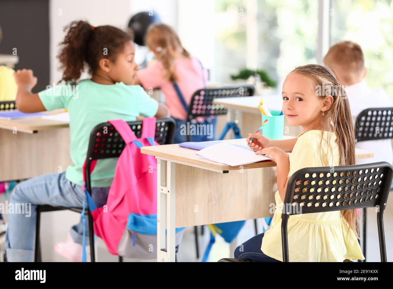 Cute schoolgirl during lesson in classroom Stock Photo - Alamy