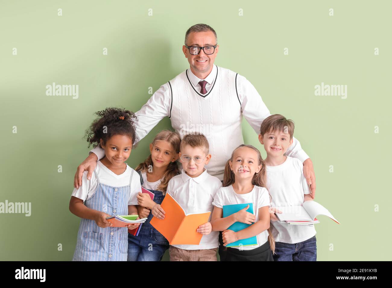 Little children with teacher on color background Stock Photo - Alamy