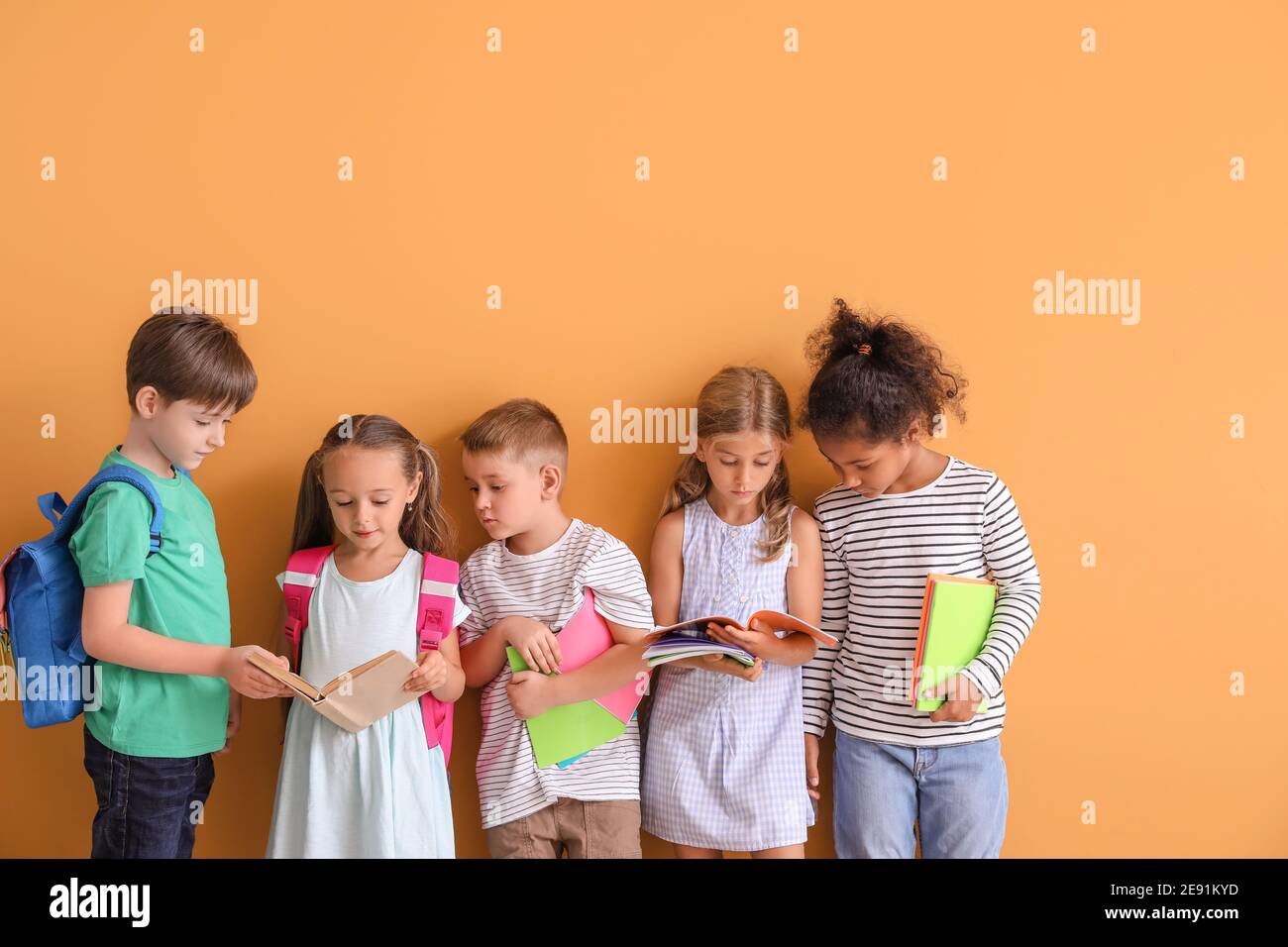 Little children with books on color background Stock Photo - Alamy