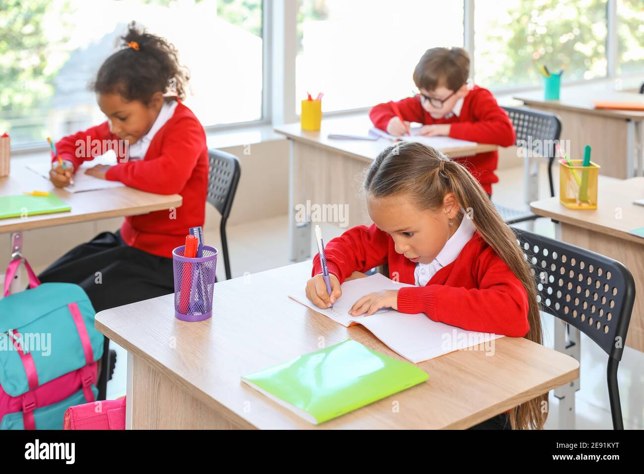 Cute children during lesson in classroom Stock Photo - Alamy