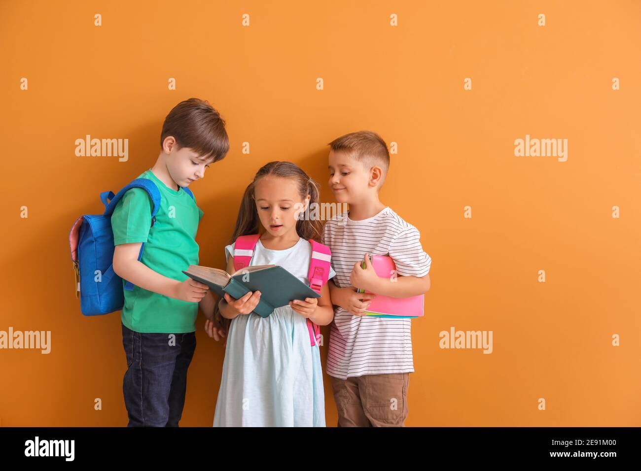 Little children with book on color background Stock Photo - Alamy