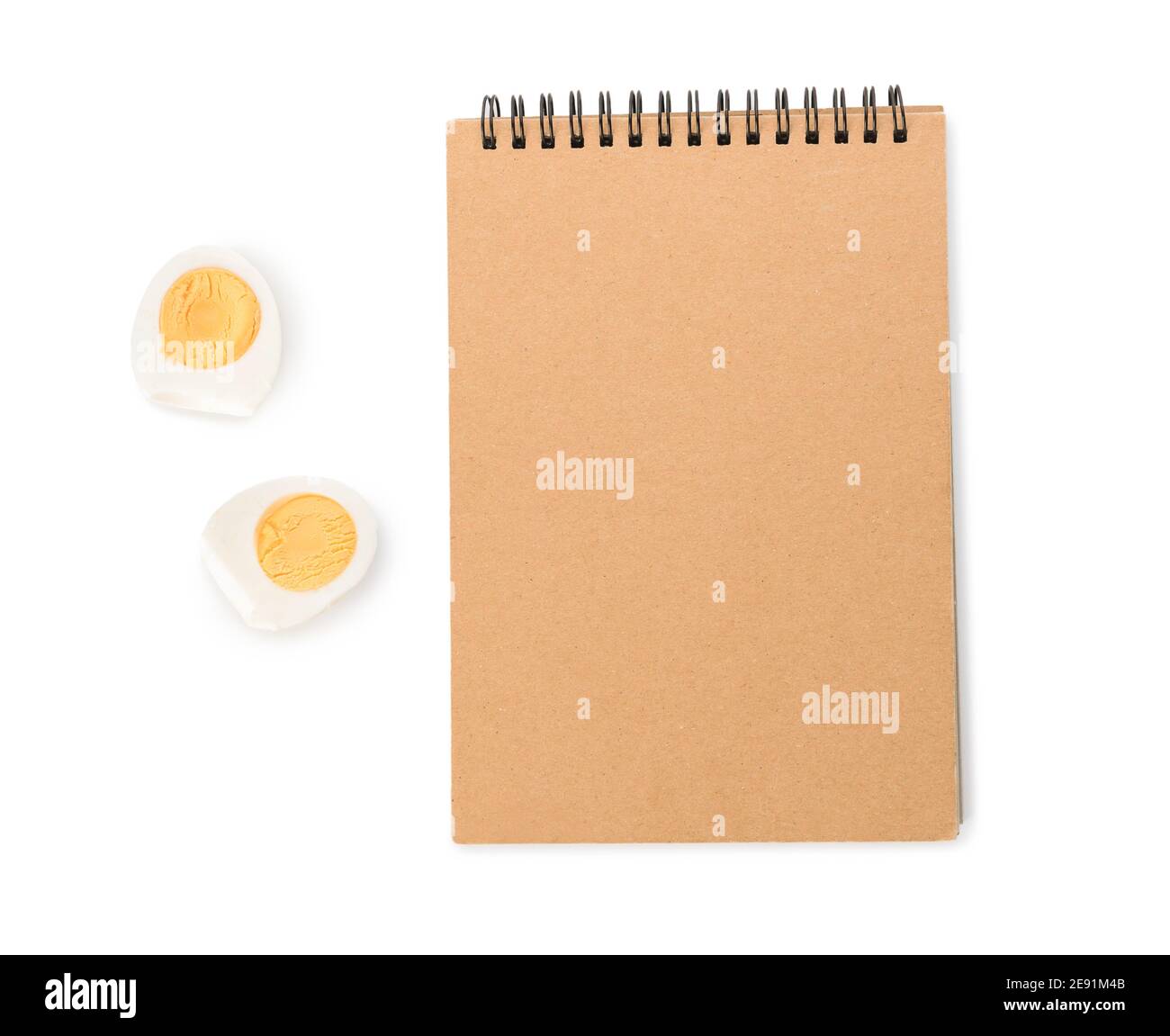 Boiled egg and notebook on white background Stock Photo - Alamy