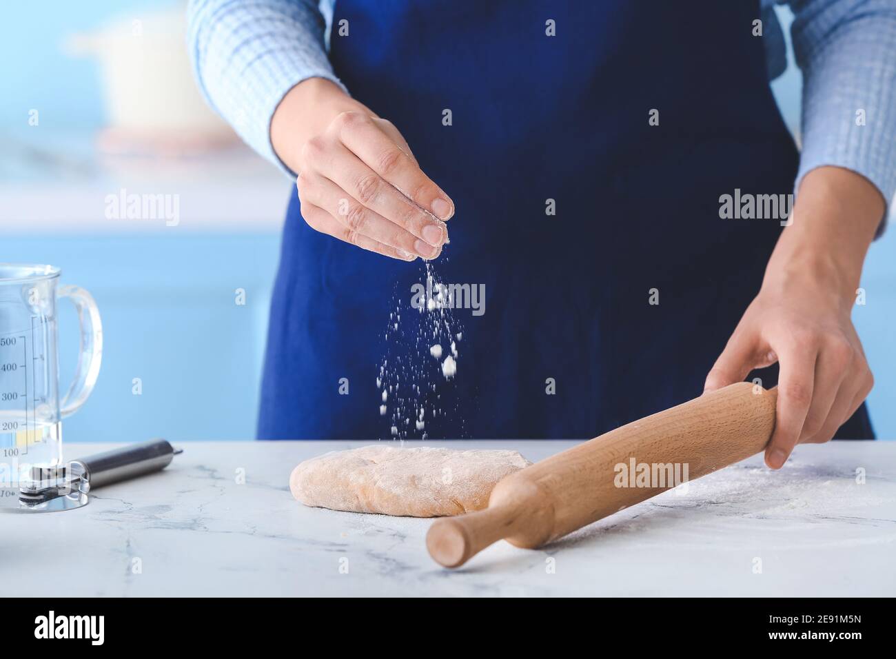 Female baker sieving flour hi-res stock photography and images - Alamy