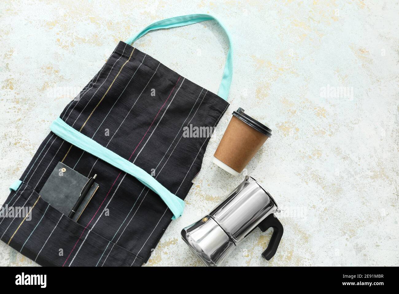 Apron, paper cup and cezve on light background Stock Photo - Alamy