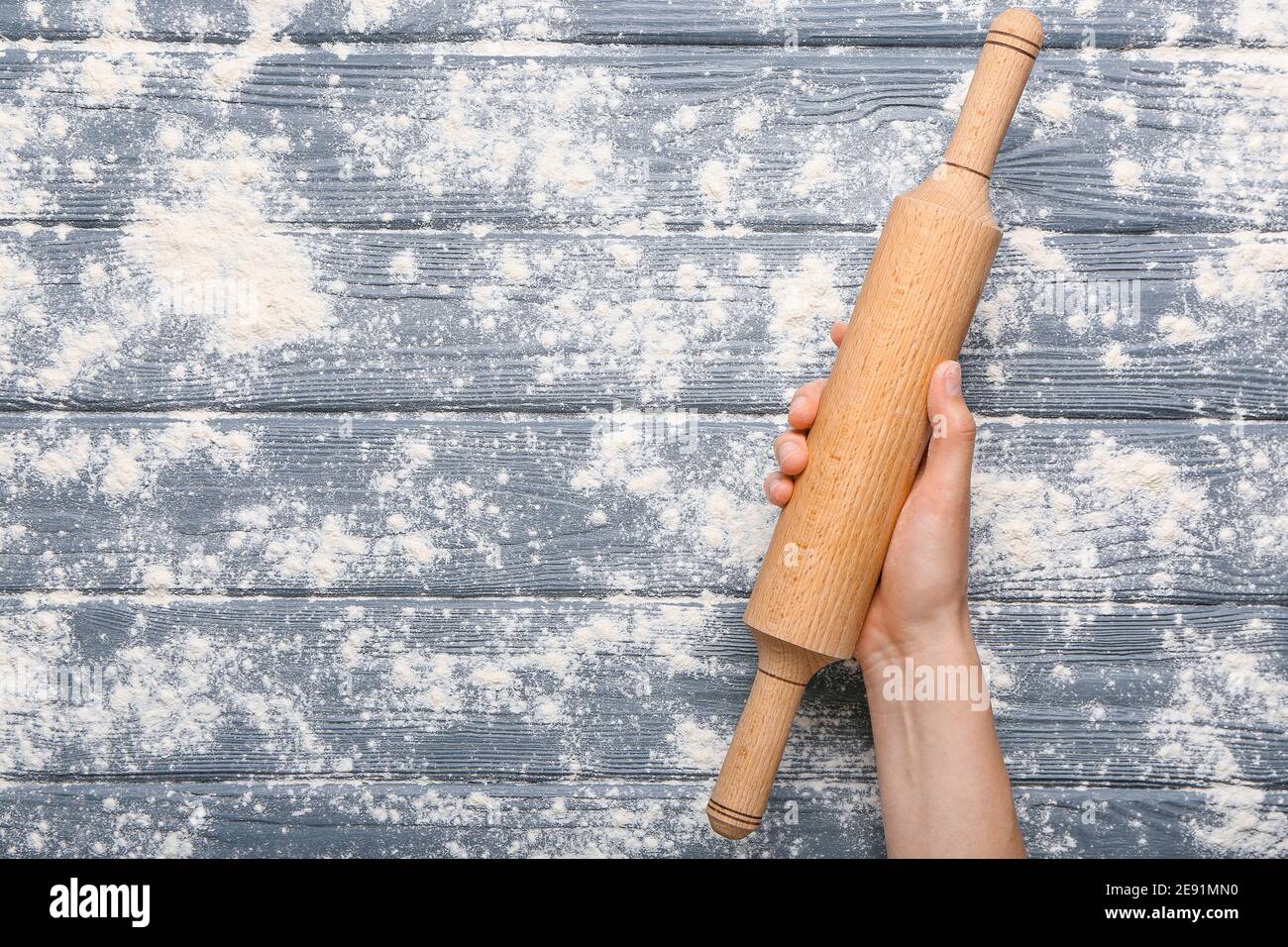 Female hand with rolling pin on wooden background Stock Photo - Alamy
