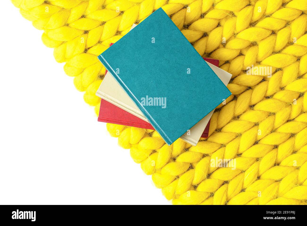 Books with knitted plaid on white background Stock Photo - Alamy