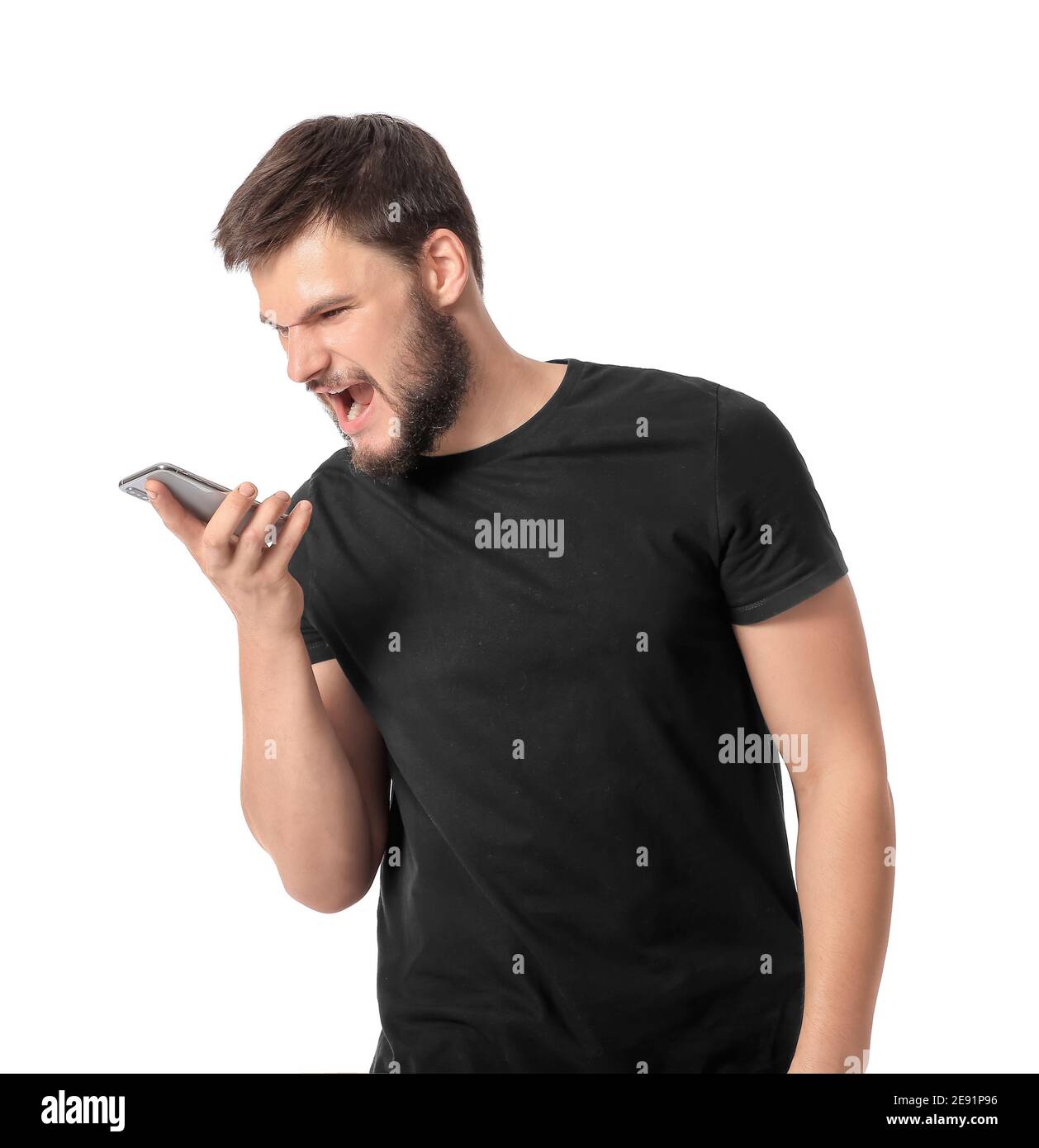 Portrait of angry man with mobile phone on white background Stock Photo ...