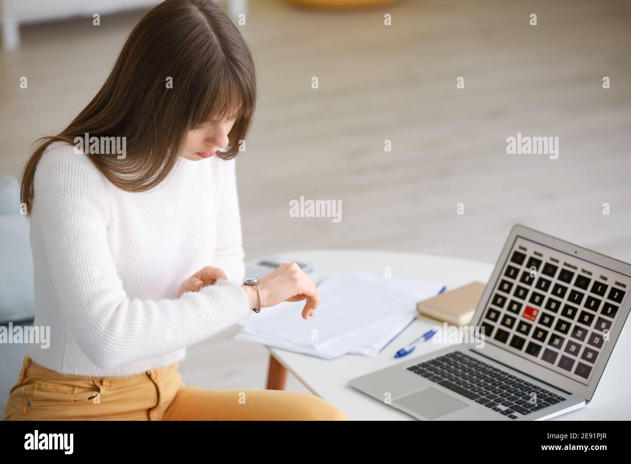 Stressed young woman trying to meet deadline at home Stock Photo - Alamy