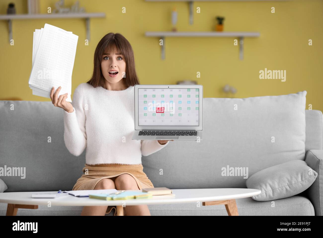 Stressed young woman trying to meet deadline at home Stock Photo - Alamy
