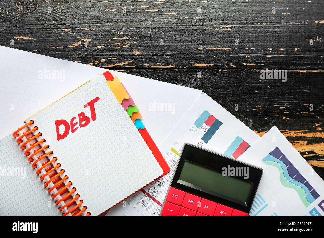 Notebook with word DEBT, documents and calculator on table Stock Photo ...