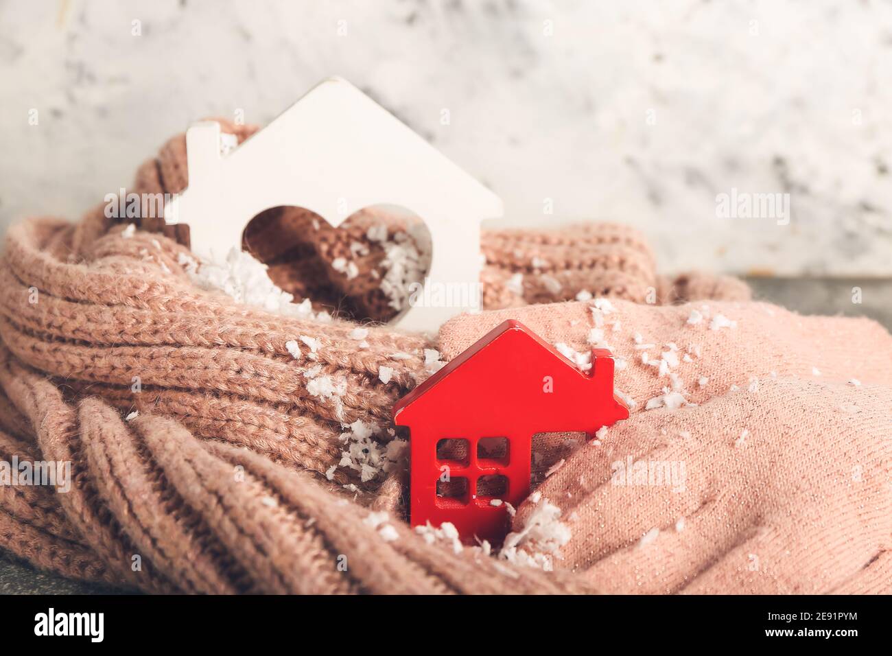 Figures of house, snow and warm clothes on grey background. Concept of ...