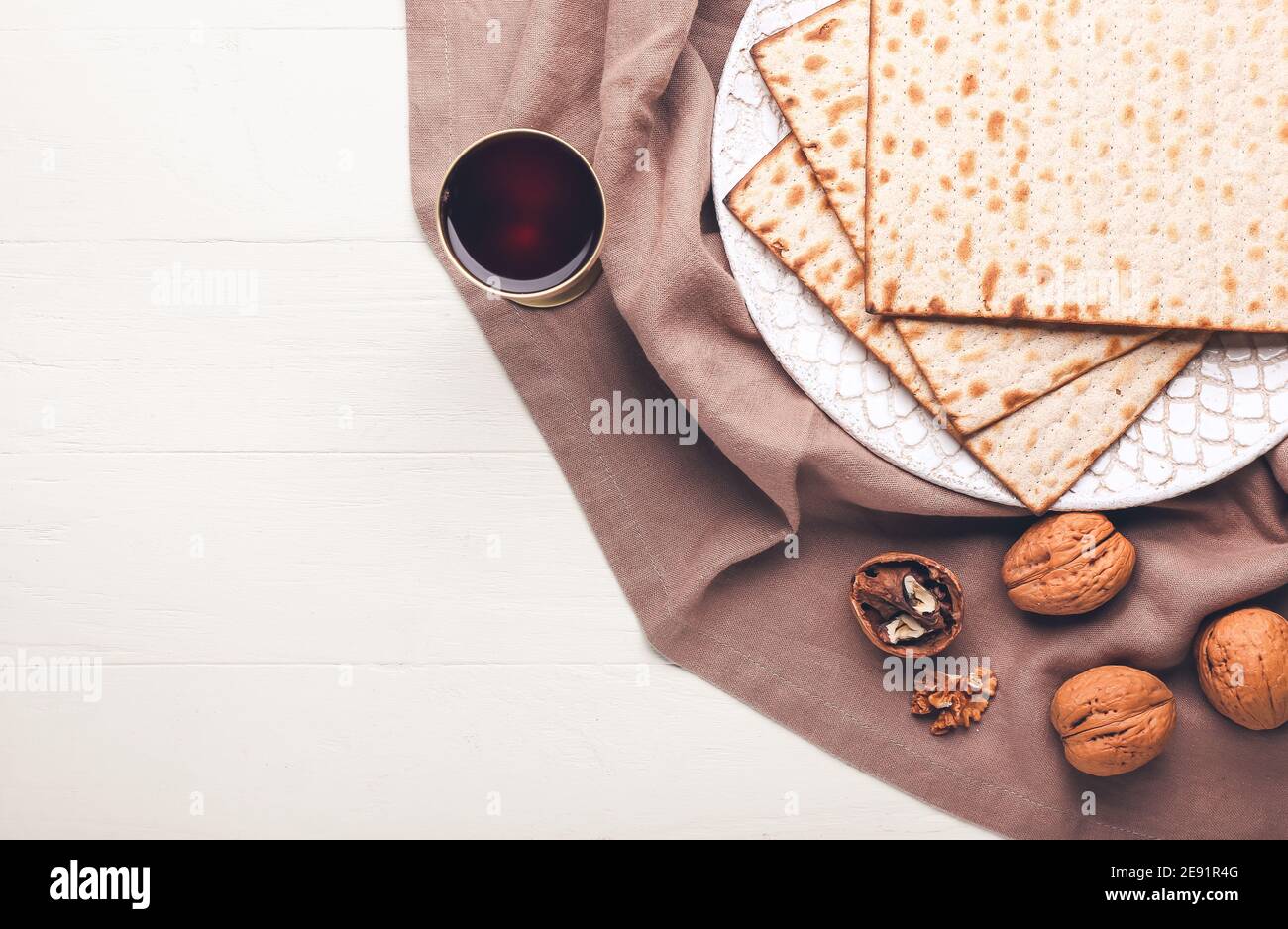 Composition with Jewish flatbread matza for Passover on white wooden ...
