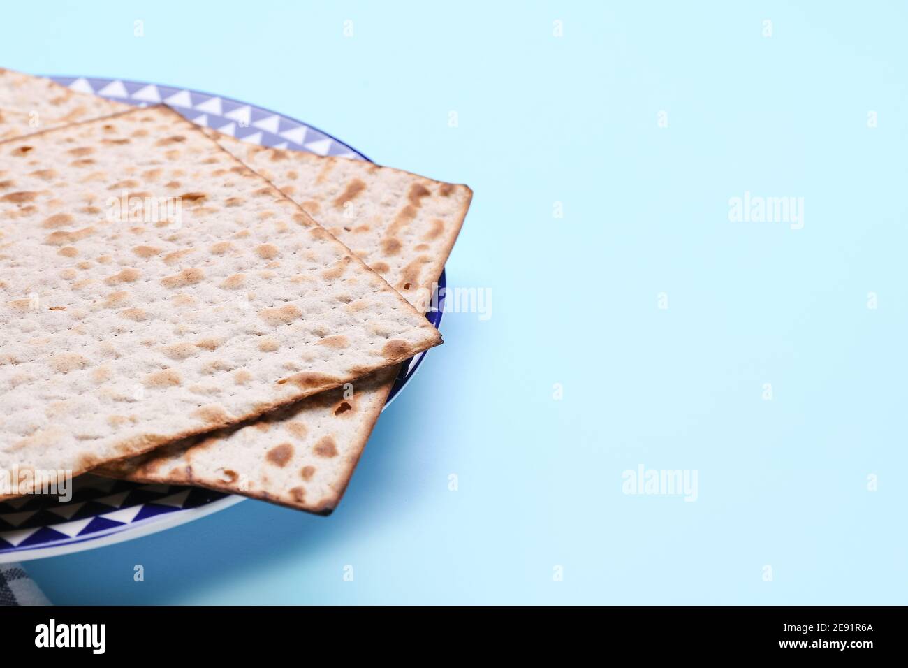 Plate with Jewish flatbread matza for Passover on color background ...