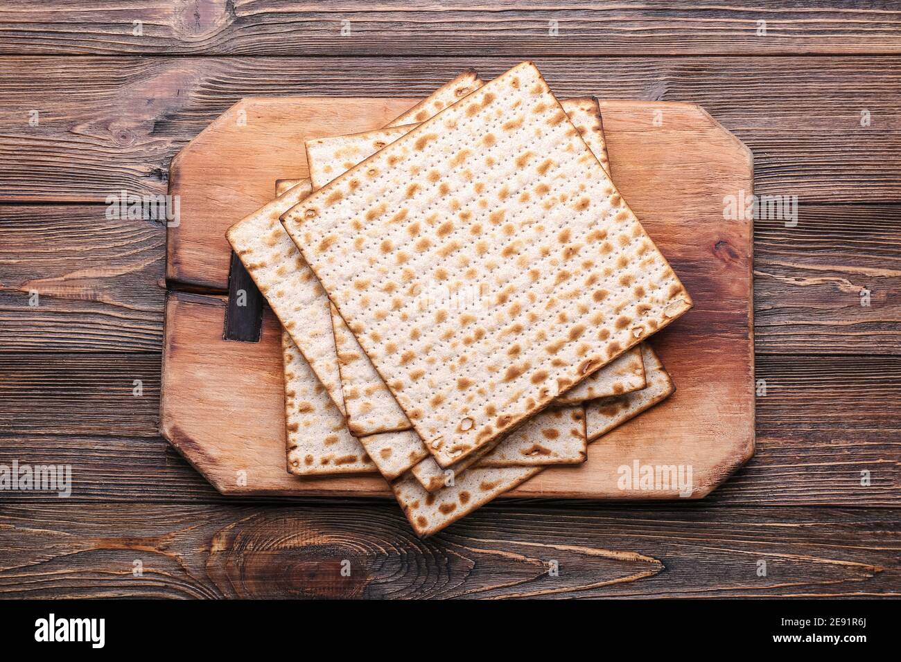 Jewish flatbread matza for Passover on wooden background Stock Photo ...