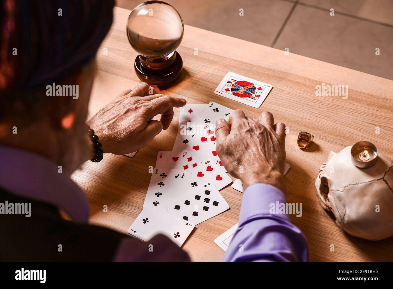 Male fortune teller with cards reading future at table Stock Photo - Alamy