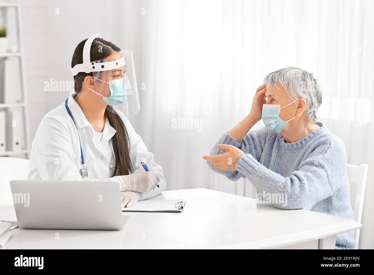 Senior woman visiting doctor in clinic Stock Photo - Alamy