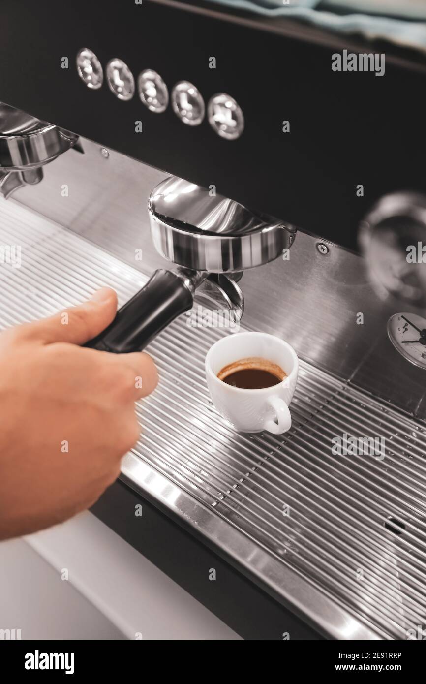 Barista making hot coffee in cafe, closeup Stock Photo - Alamy