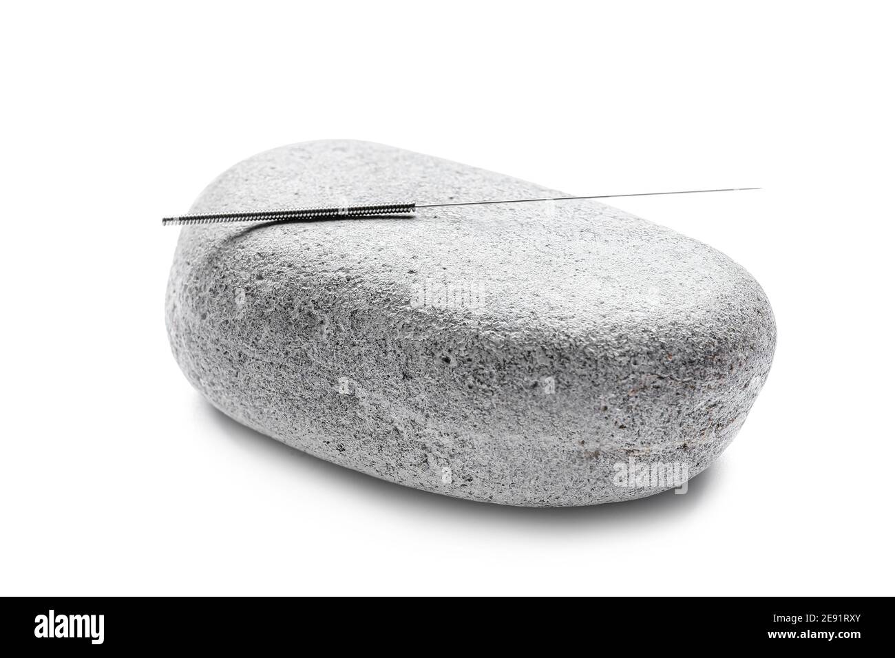 Acupuncture needle and spa stone on white background Stock Photo - Alamy