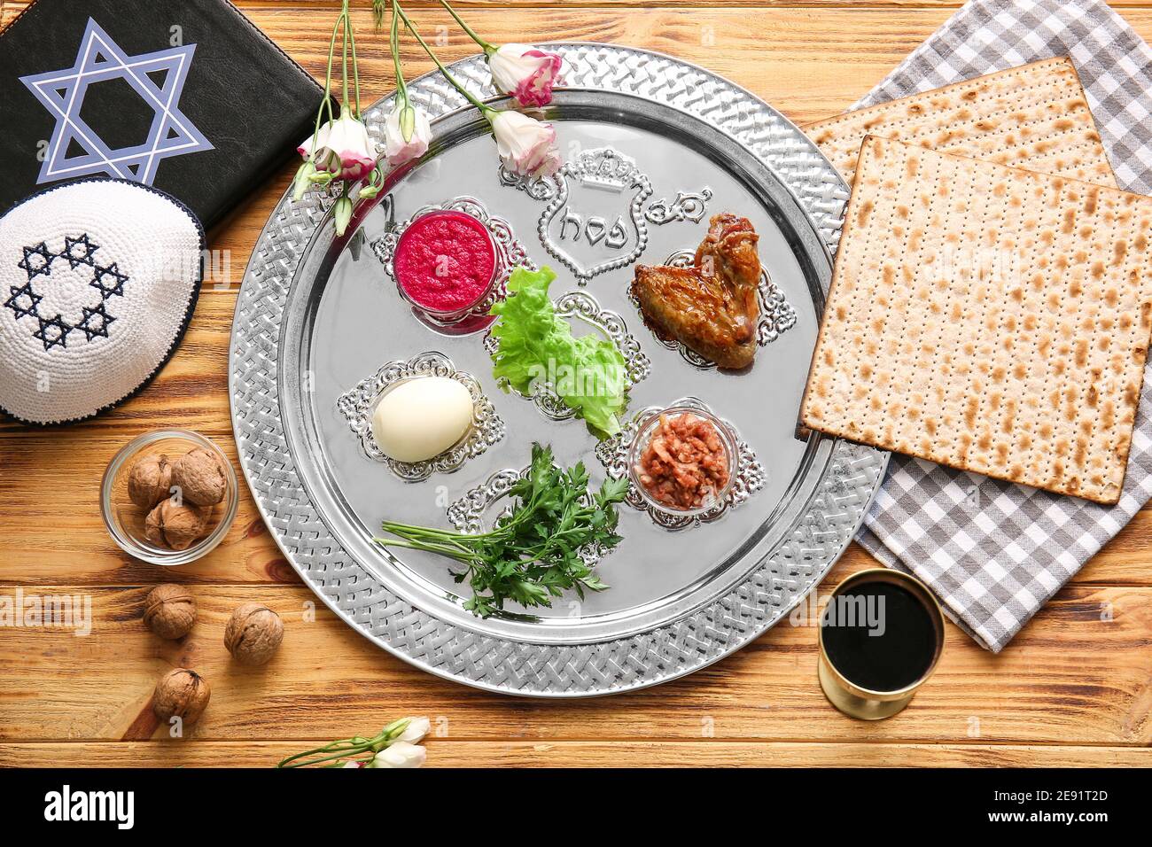Passover Seder plate with traditional food, Torah and Jewish cap on ...