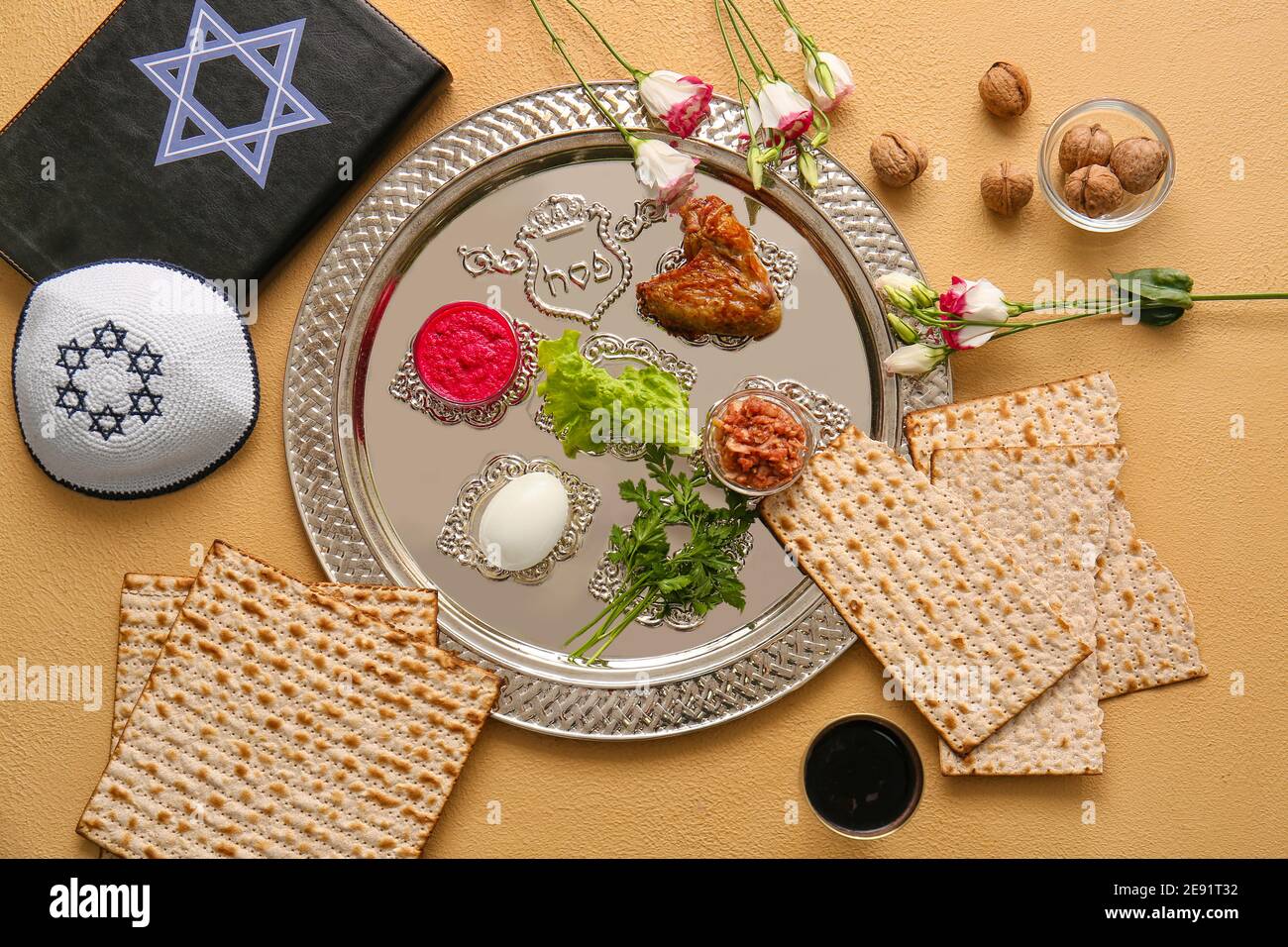 Passover Seder plate with traditional food, Torah and Jewish cap on ...