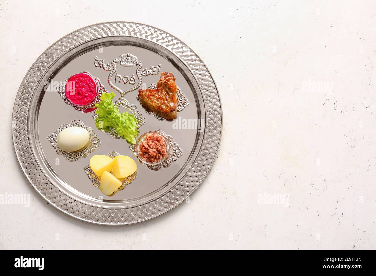 Passover Seder plate with traditional food on white background Stock ...