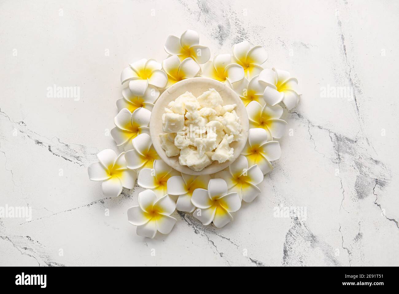 Plate with shea butter and flowers on white background Stock Photo - Alamy