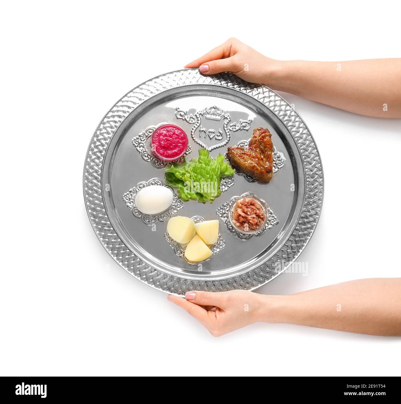 Female hands with Passover Seder plate and traditional food on white ...