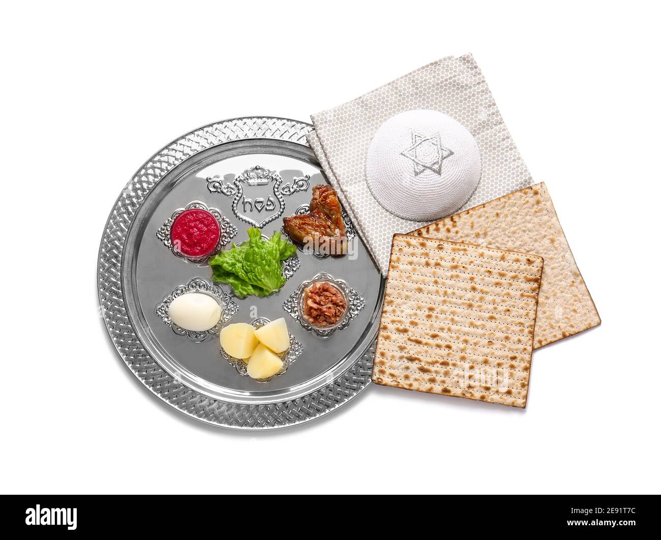 Passover Seder plate with traditional food and Jewish cap on white ...
