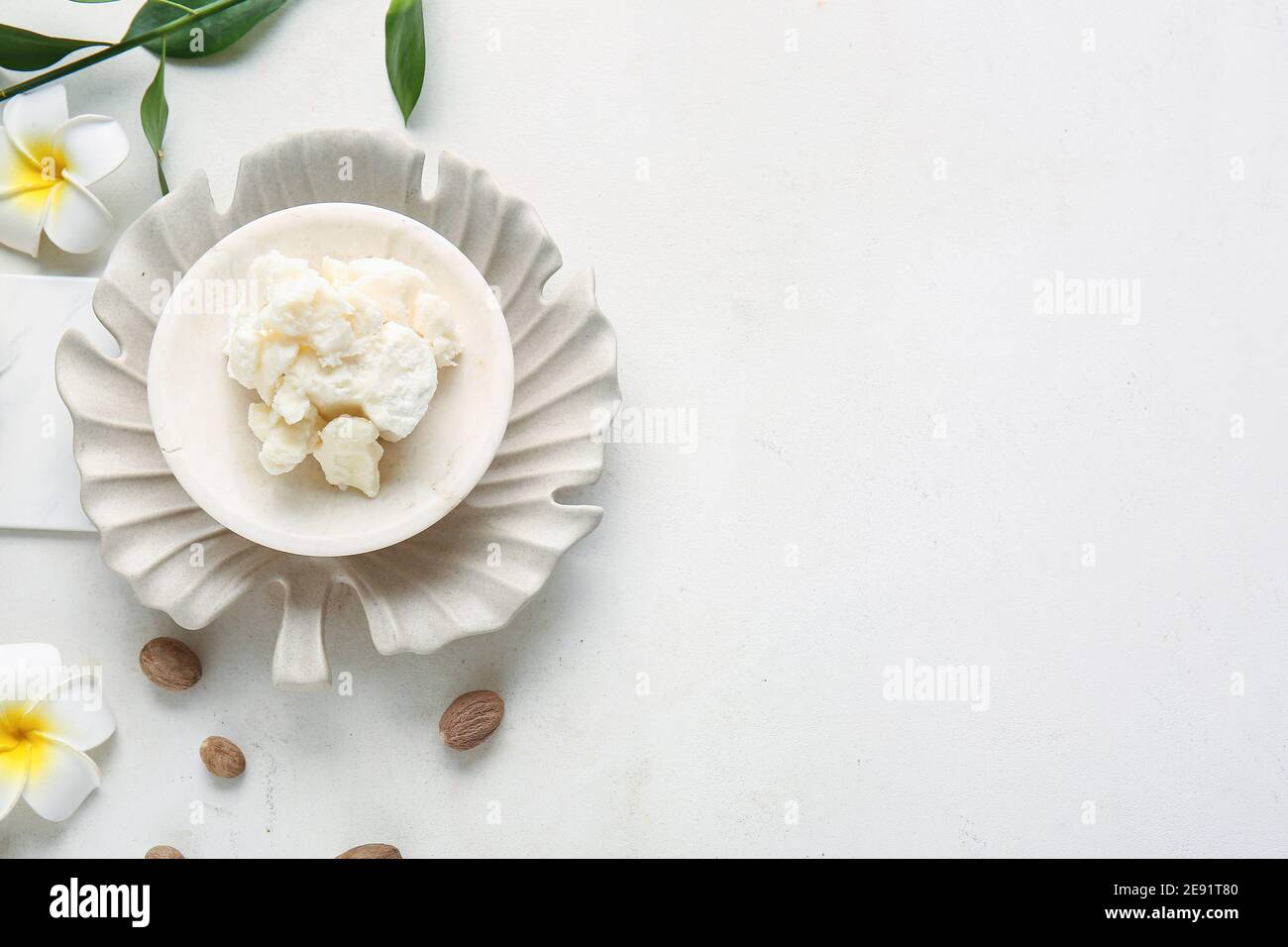 Shea butter on white background Stock Photo - Alamy