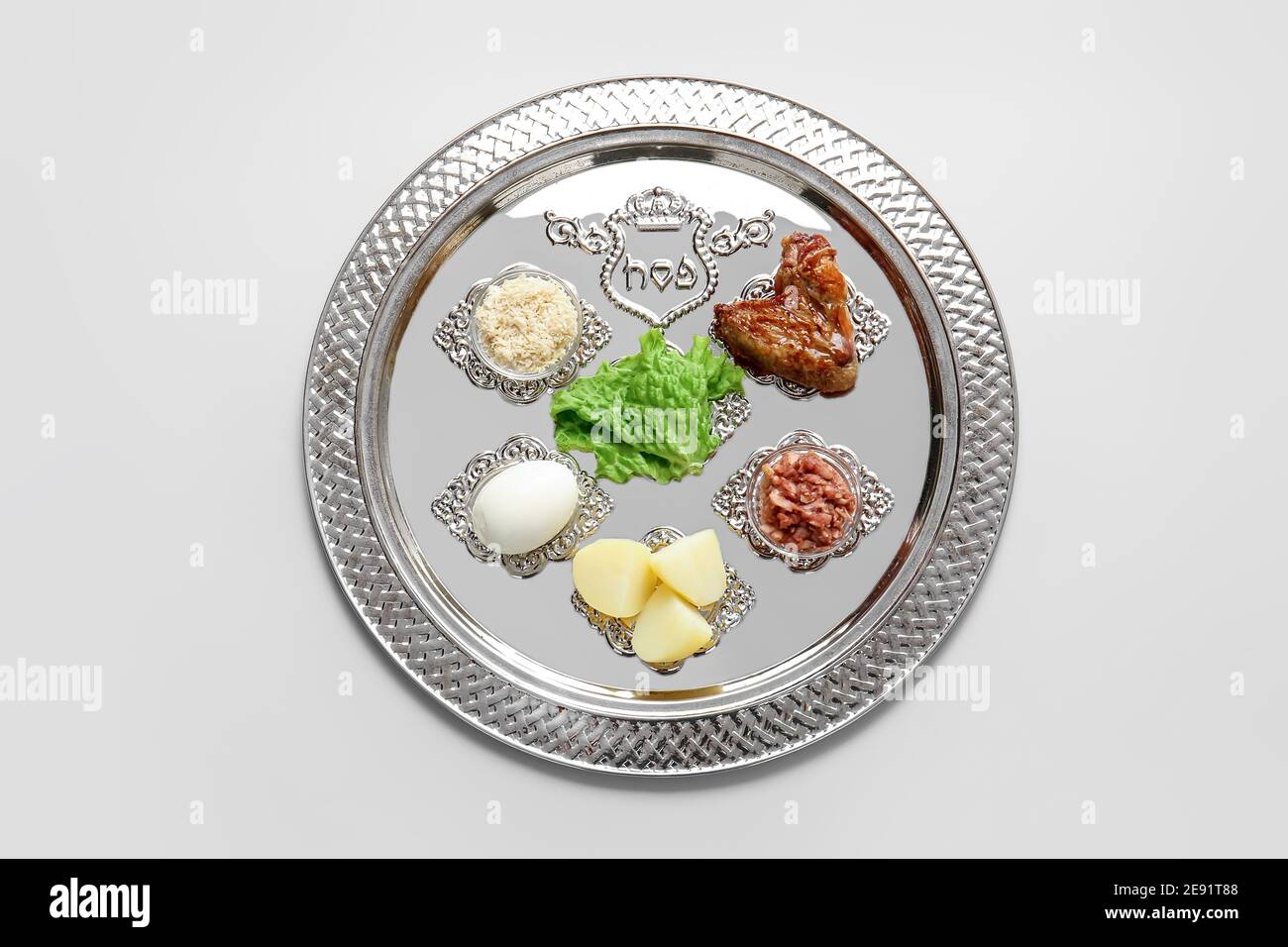 Passover Seder plate with traditional food on light background Stock ...