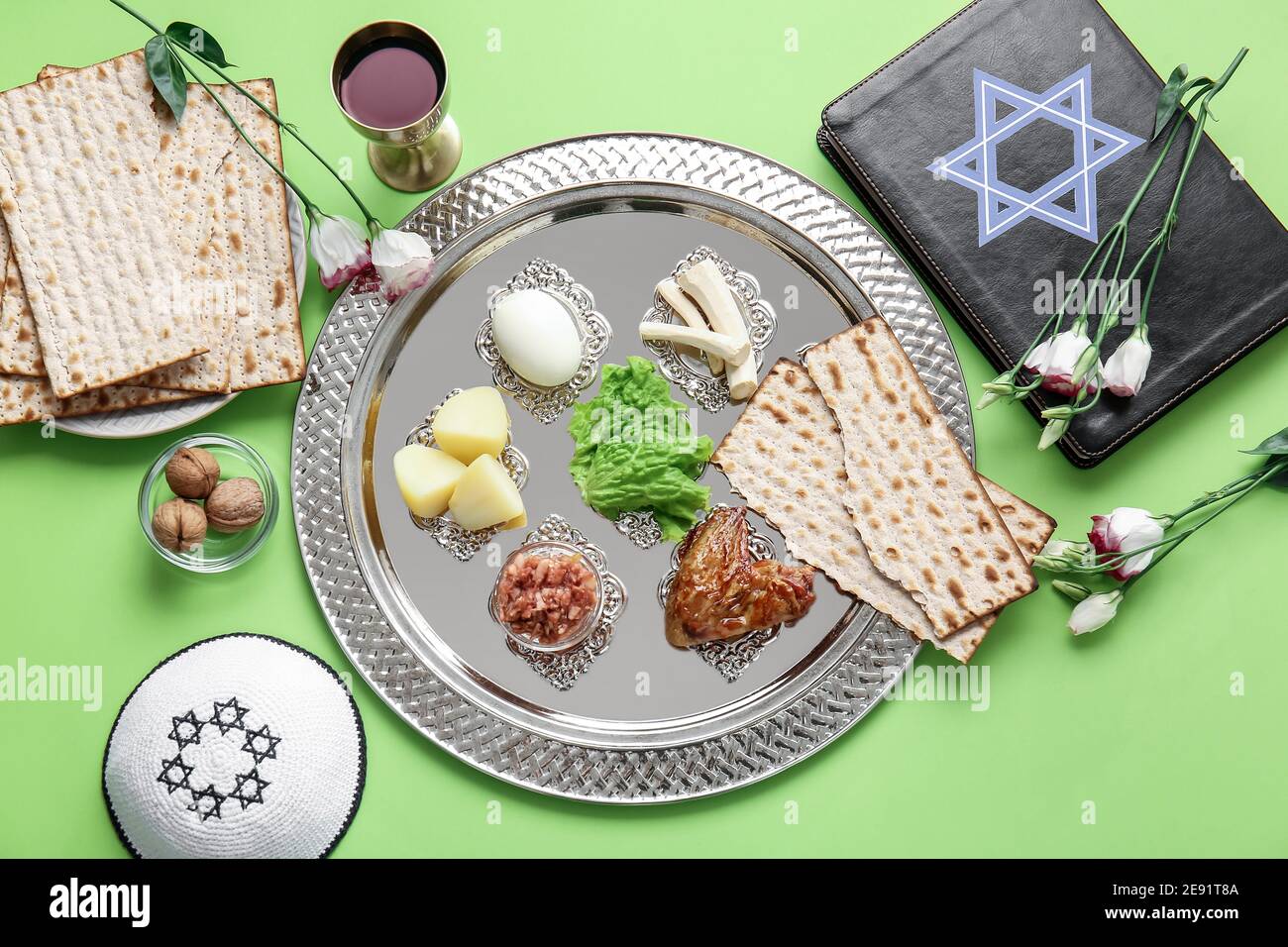 Passover Seder plate with traditional food, Torah and Jewish cap on ...