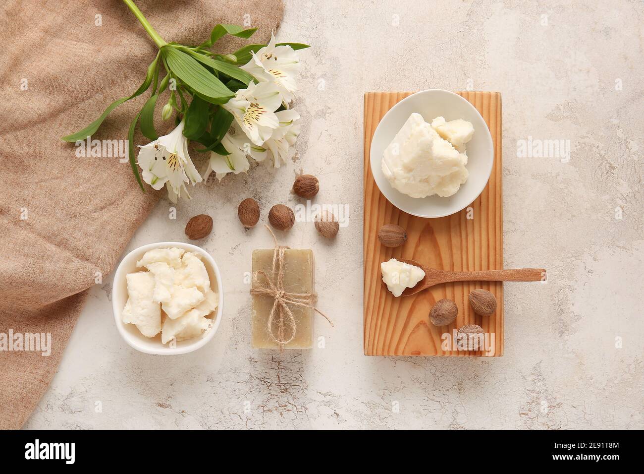 Shea butter with soap on grey background Stock Photo - Alamy