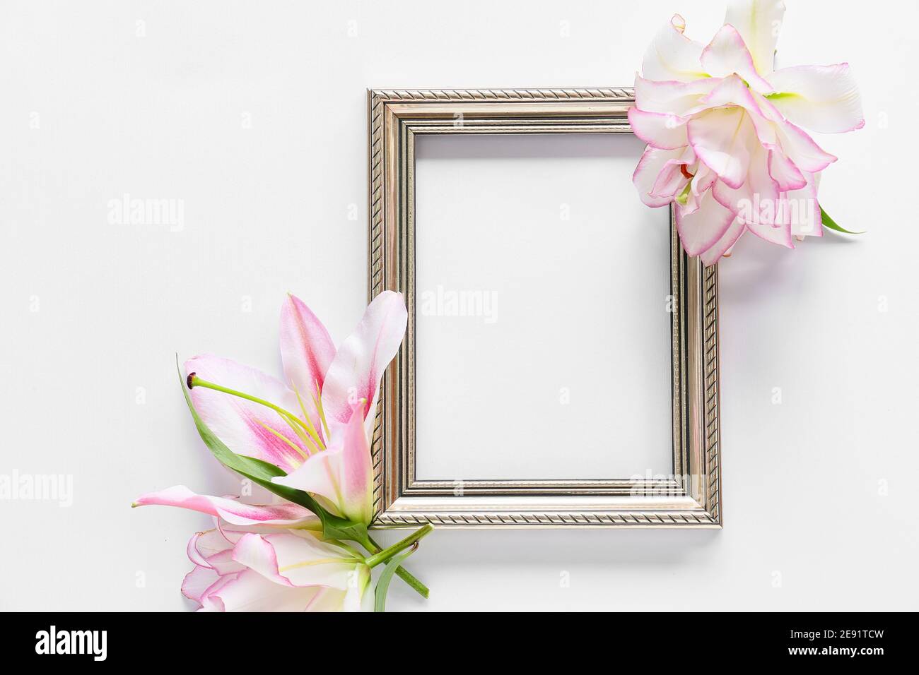 Beautiful lilies and frame on white background Stock Photo - Alamy